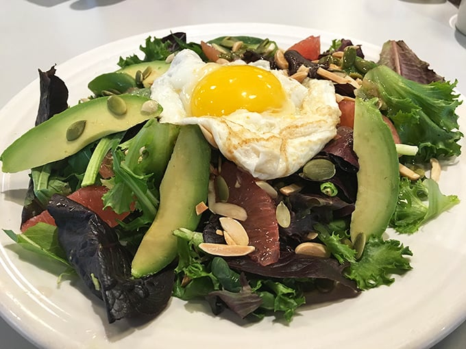 The Fresh Start Breakfast Salad proves that "healthy" and "delicious" aren't sworn enemies – that sunny egg is the crown jewel.