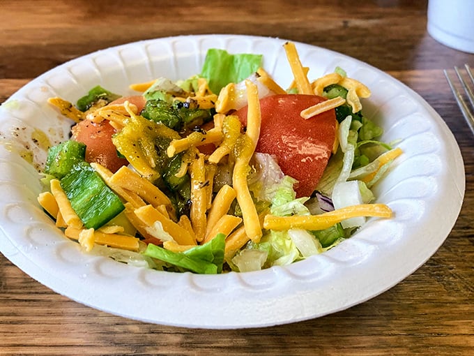 Even the salad has Southern hospitality—fresh greens topped with generous handfuls of cheese, proving vegetables can be friendly when properly introduced to their dairy companions.