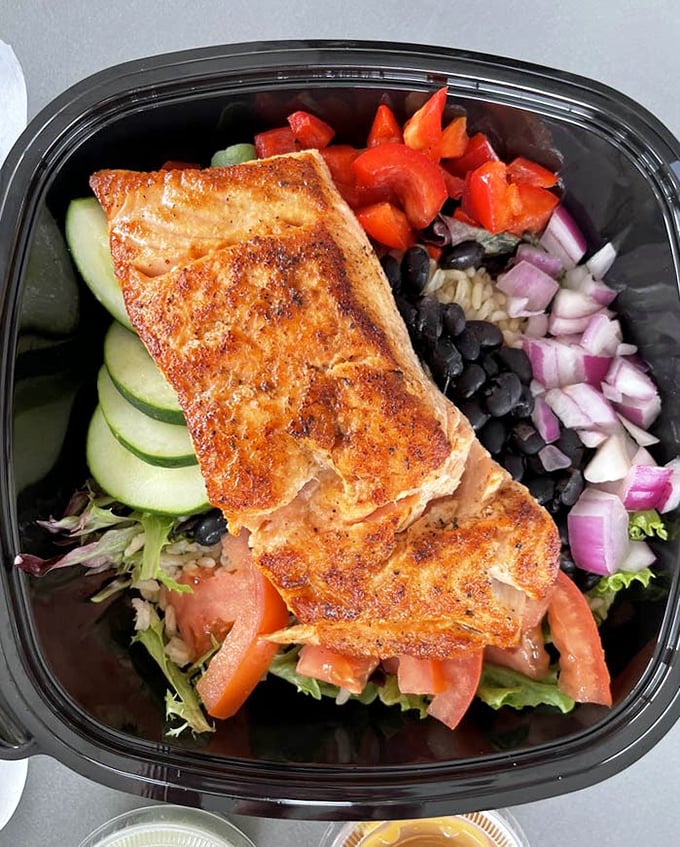 Who knew healthy could look this good? Perfectly seared salmon atop a garden of vegetables—like a Florida sunset captured in food form.
