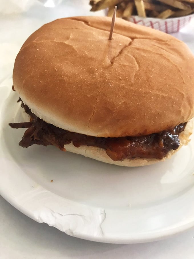 The barbecue sandwich—tender, saucy perfection on a bun that proves sometimes the simplest pleasures deliver the most profound satisfaction.
