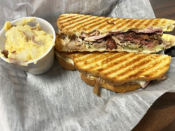 This grilled sandwich isn't just lunch—it's structural engineering at its finest, with layers of smoked meat defying gravity between perfectly toasted bread.