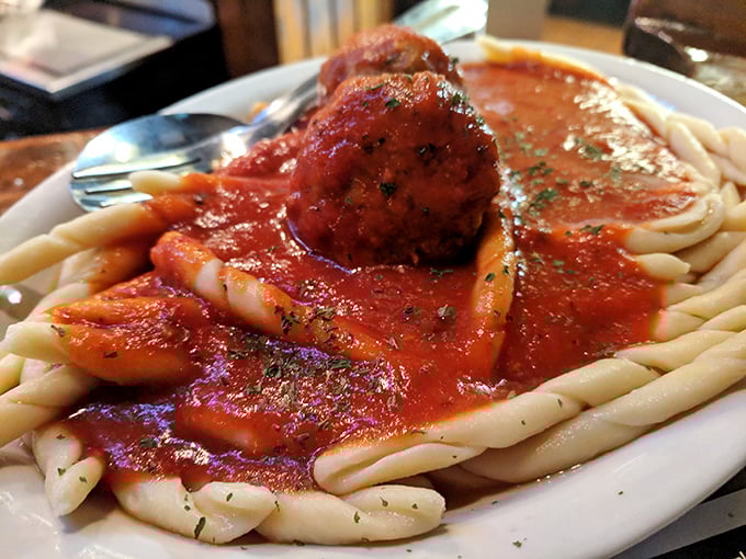 Pasta that doesn't need fancy plating to impress – just a perfectly formed meatball and sauce that speaks volumes about tradition.