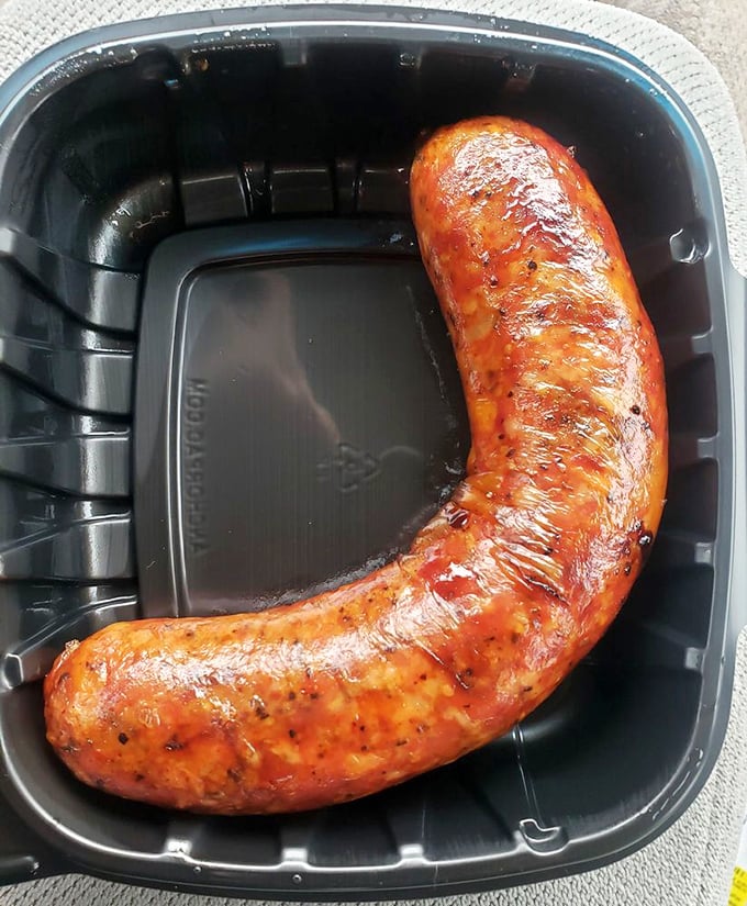 This sausage link curves like a Texas highway, glistening with smoky promise and enough spice to wake up.