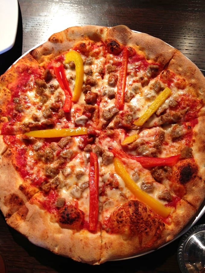 Sausage and peppers pizza that would make Tony Soprano weep with joy—simple ingredients elevated to art form.