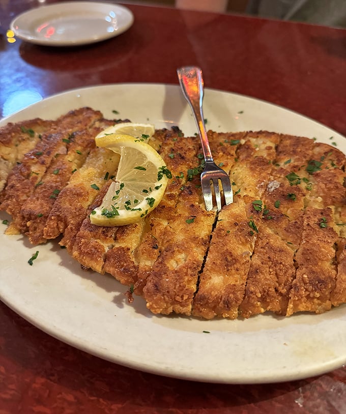 This schnitzel isn't just pounded thin—it's been persuaded into submission. Crispy, golden perfection with a squeeze of lemon that brightens every magnificent bite.