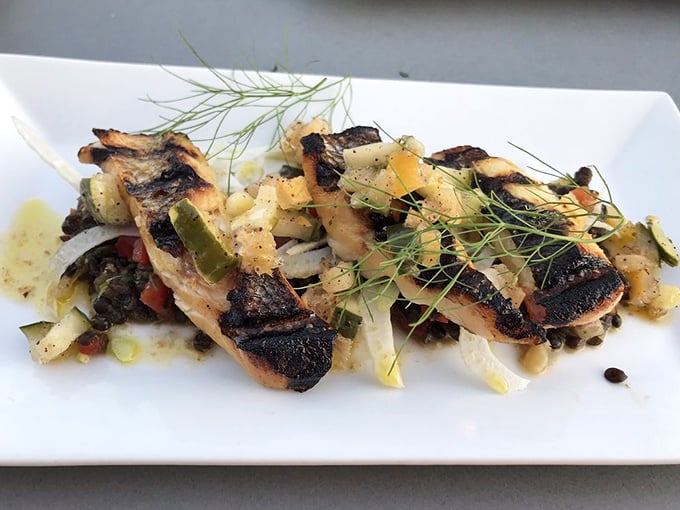 Grilled fish that tastes like the Mediterranean vacation you deserve—delicate sea bass with charred edges and bright herbs speaking the language of coastal Sicily.
