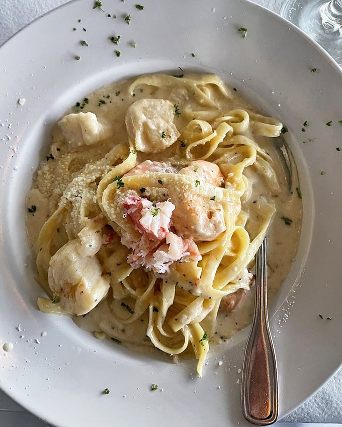 Seafood Alfredo that defies gravity – somehow rich yet light, with tender seafood playing hide-and-seek among perfectly cooked fettuccine ribbons.