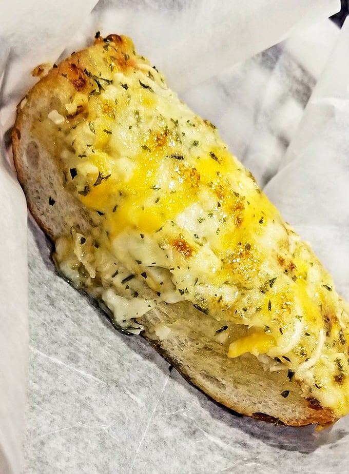 Garlic bread that doesn't whisper but shouts its cheesy, buttery intentions—the perfect tool for sopping up every last drop of that precious sauce.