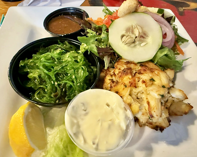 A plate that tells a story of the sea—crab cake as the protagonist, seaweed salad as the supporting character, and your taste buds as the grateful audience.