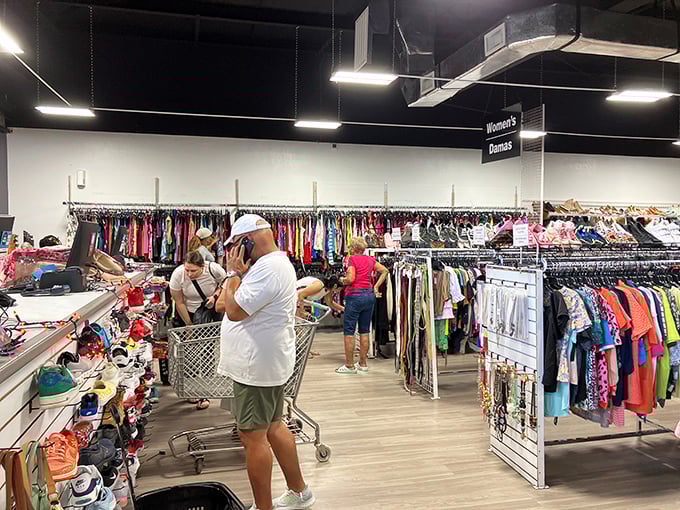 The thrill of the hunt in action—fellow bargain archaeologists carefully excavating through racks for that perfect piece to take home.