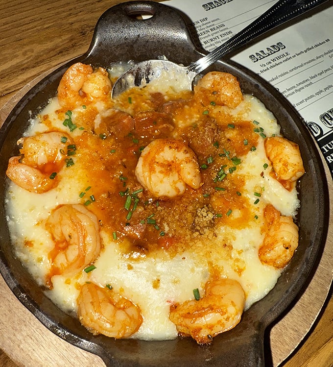 Shrimp and grits elevated to an art form—creamy, cheesy goodness topped with perfectly seasoned shrimp and a sprinkle of chives.