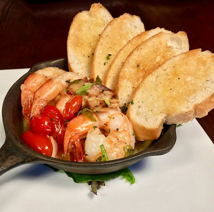 Shrimp that look like they just had a spa day, lounging with roasted tomatoes and toasted bread—seafood that's dressed to impress.