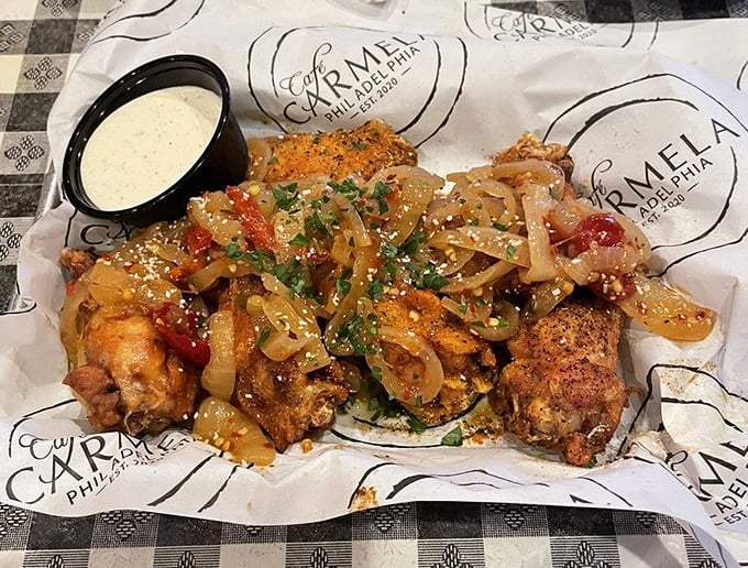 These wings, glistening with sauce and topped with caramelized onions, aren't trying to be polite. They're here to make memories.