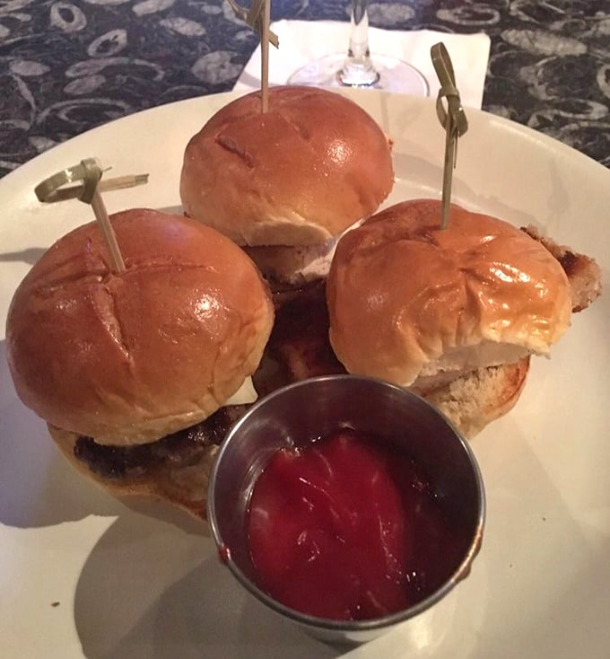These sliders aren't "mini burgers"—they're perfectly proportioned flavor bombs, served with a side of nostalgia and house-made condiments.