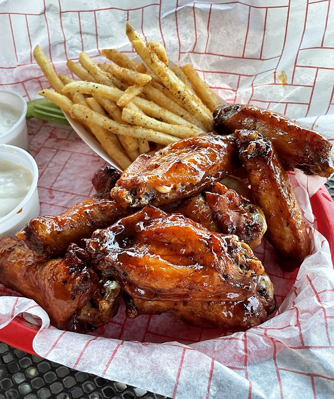 Wings glistening with sauce like they just stepped out of a BBQ fashion magazine. These aren't just wings—they're flavor delivery vehicles of the highest order.