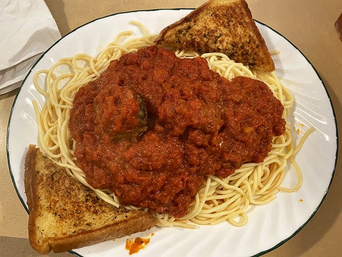 Spaghetti and meatballs with sauce so generous it's practically a lake of tomato goodness. Garlic toast: the perfect sauce-sopping vessel.