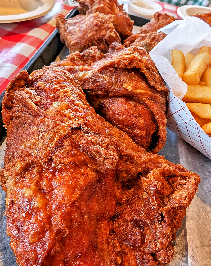 A mountain of spicy, crispy chicken that makes you understand why people line up outside. That color isn't just for show—it's a promise of flavor.