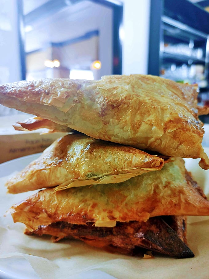 These flaky pastry triangles aren't just filled with spinach—they're packed with Mediterranean sunshine and the kind of flavor that makes you reconsider your life choices.