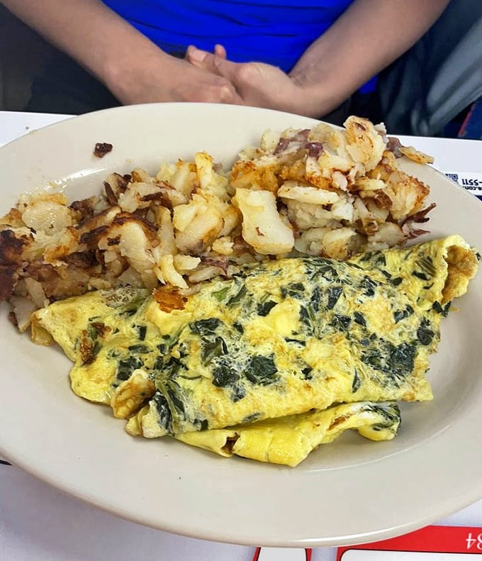 This spinach and feta omelet isn't just breakfast—it's edible sunshine paired with potatoes that have been properly introduced to butter.
