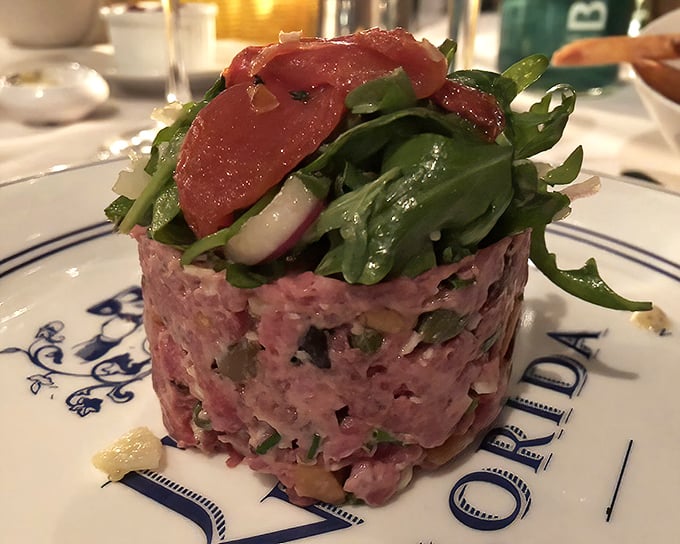 Steak tartare that's dressed better than most people at the opera—a symphony of flavors topped with delicate greens.
