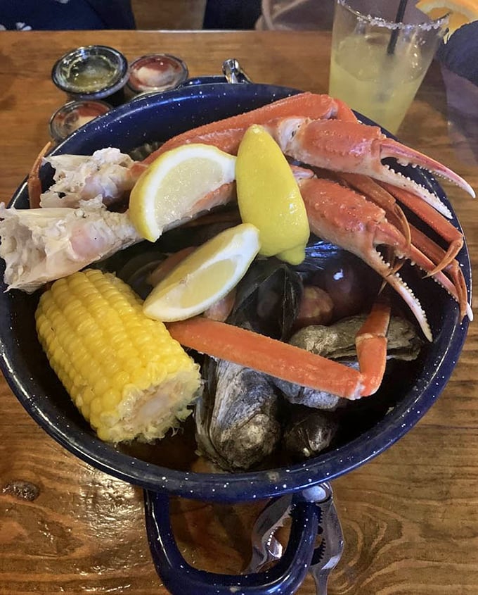 The Steampot Seafood Boil arrives like a treasure chest of the sea – crab legs, corn, and all the fixings for a gloriously messy feast.