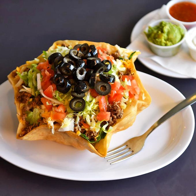 This taco salad isn't just a meal, it's an edible bowl of joy topped with a mountain of olives, tomatoes, and lettuce.