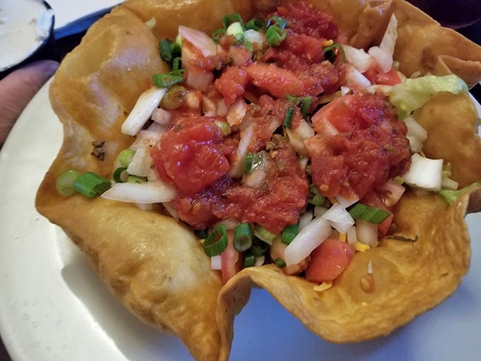 Not your average taco salad – this crispy tortilla bowl cradles a fiesta of fresh ingredients that somehow makes you feel virtuous while indulging.