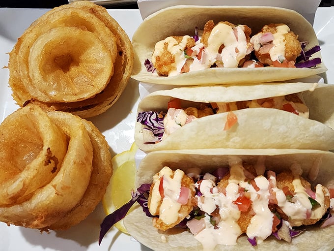 Crispy tacos flanked by golden onion rings—proof that Samosky's knows comfort food extends well beyond the pizza universe.