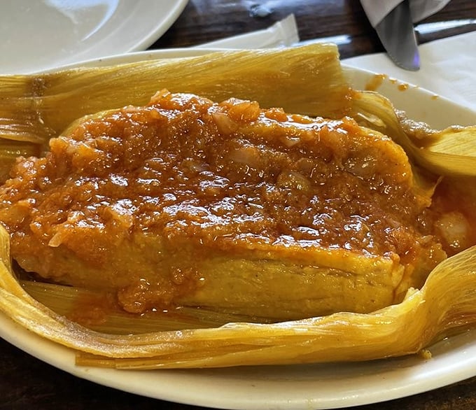 Not just any tamale—this is abuela-approved comfort wrapped in corn husks and topped with a sauce worth bottling.