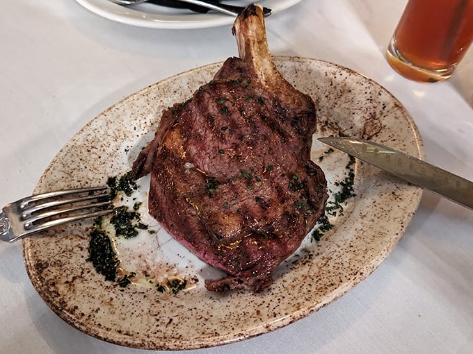 The tomahawk steak arrives like prehistoric satisfaction on a plate. Fred Flintstone would weep with joy at this carnivorous masterpiece.