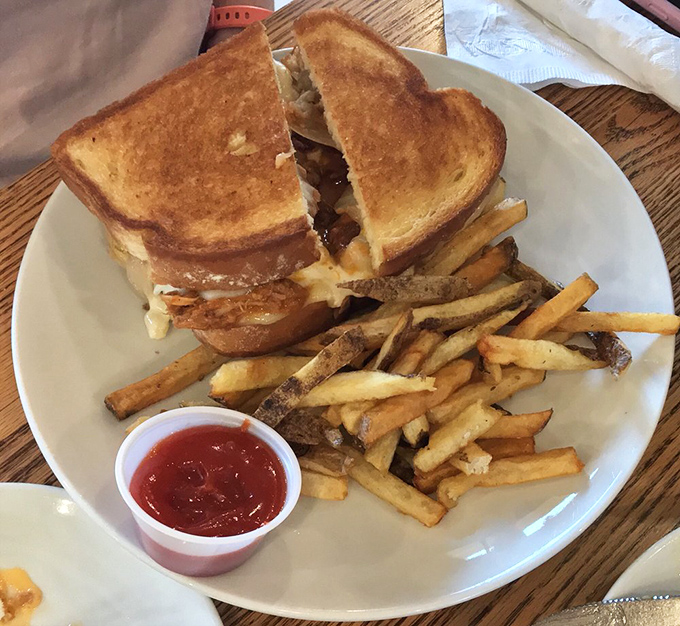 The sandwich that launched a thousand road trips—perfectly grilled bread holding melty cheese and savory fillings, with fries that didn't come from a freezer.