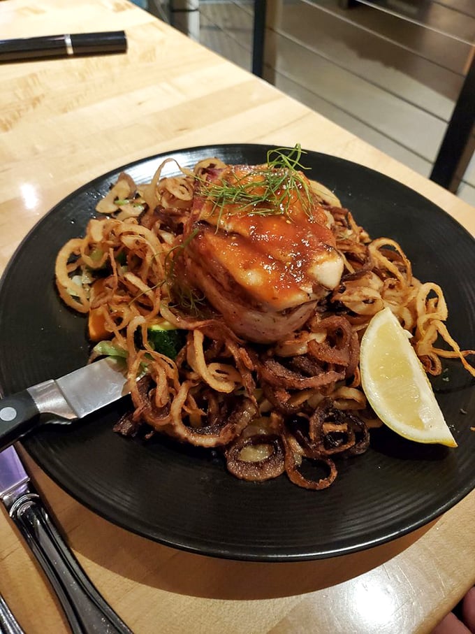 Tuna mignon perched atop crispy onion strands—a tower of flavor that makes you wonder why you ever bothered with landlubber steaks in the first place.
