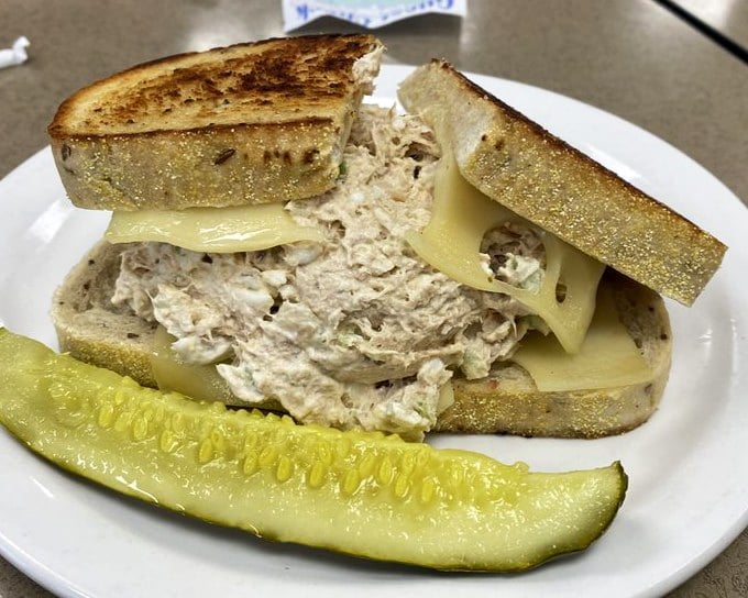 A tuna melt that respects tradition while delivering comfort. The pickle isn't just garnish—it's the acidic counterpoint this sandwich masterpiece demands. 