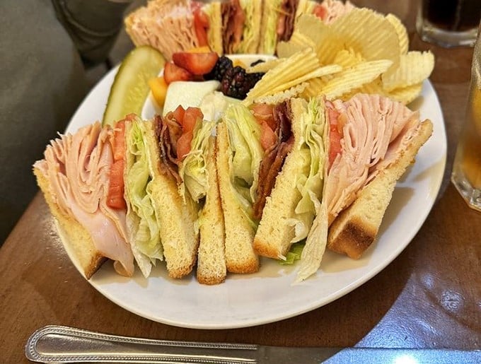 A club sandwich that's architectural marvel meets flavor explosion—proof that sometimes the best things in life come between bread slices.