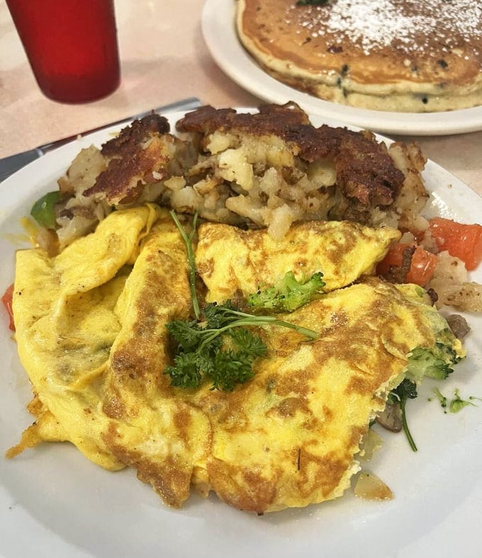 A proper Wisconsin omelet: fluffy eggs embracing fresh vegetables with the kind of cheese pull that would make a food photographer weep.