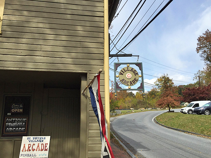 The Village Arcade sign swings gently in the breeze, beckoning nostalgic gamers to relive the days when quarters were currency and high scores mattered.