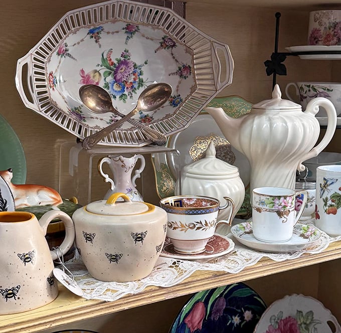 A tea party frozen in time—bee-patterned pottery, delicate floral teacups, and porcelain serving pieces await their next gathering of gossip and finger sandwiches.