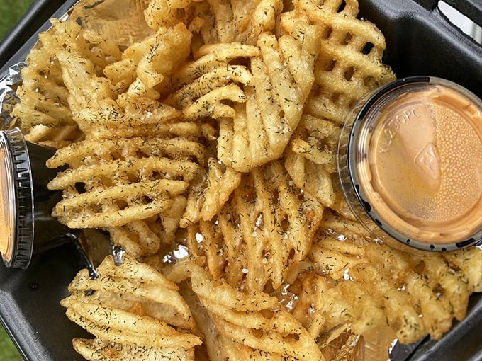 These aren't just waffle fries—they're crispy, seasoned vehicles engineered specifically for sauce transportation. The dipping cup awaits its destiny.