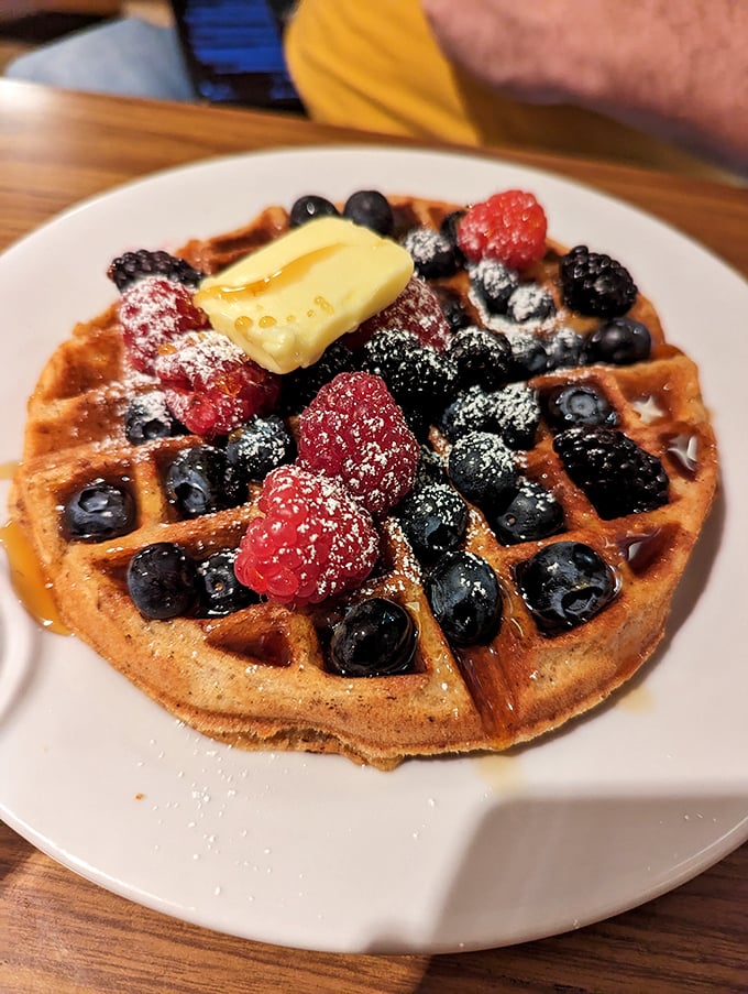 This isn't just a waffle—it's architecture with berries. The butter melting into those perfect squares is nature's most beautiful geometry.