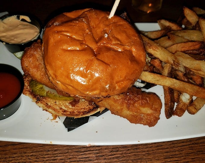 This isn't just a burger – it's architecture, engineering, and art stacked between buns with fries standing at attention alongside.