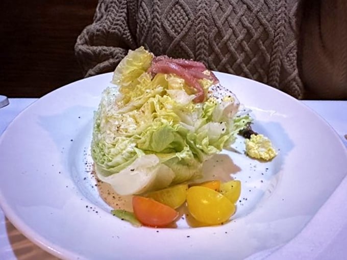 The wedge salad – that rare instance where iceberg lettuce gets to dress up fancy and remind everyone it still belongs at the grown-ups' table.