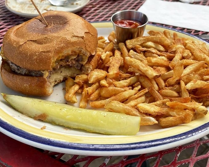 The classic American burger gets elevated with golden fries and a pickle spear—a trio that's been making bad days better since time immemorial.