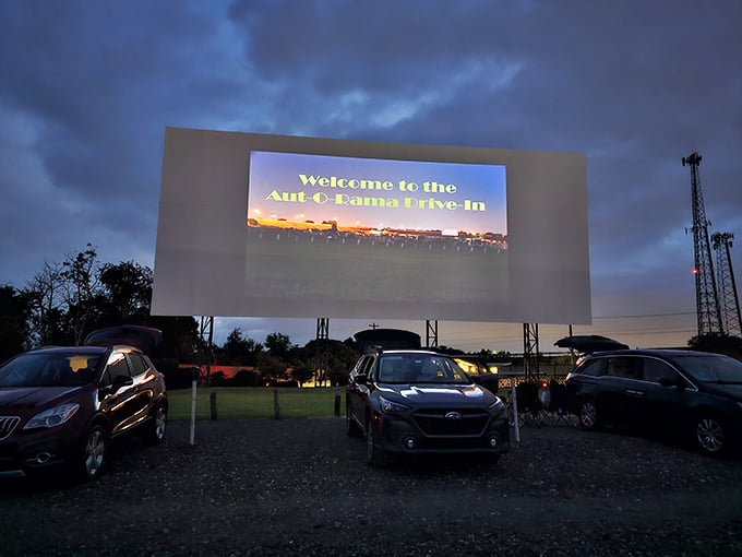 As dusk settles, the welcome message glows to life—the modern world fades away and for the next few hours, nothing exists beyond this gravel lot.