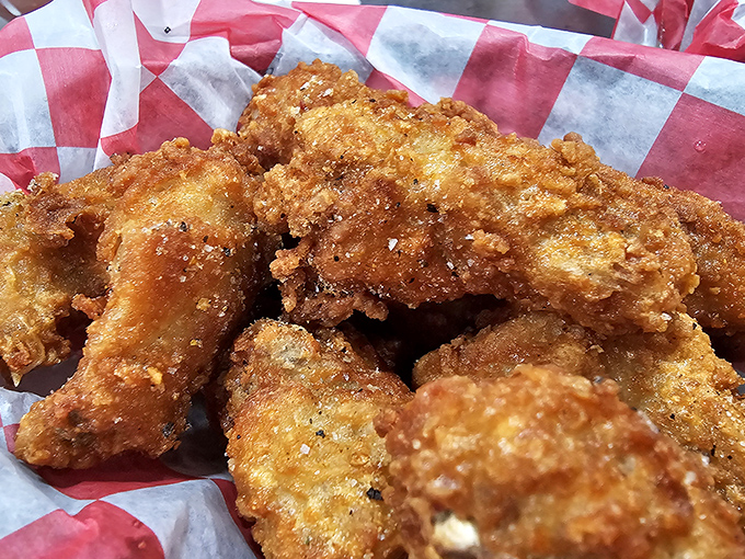 Golden-fried chicken wings that crunch louder than your diet plans breaking. These aren't just wings—they're crispy vessels of joy.