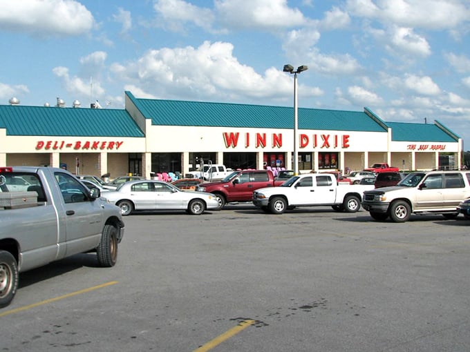 The Winn-Dixie parking lot – where golf carts and pickup trucks coexist in harmony, much like the retirees and locals inside.