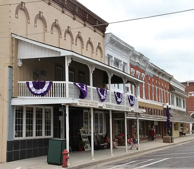 Yoder's Homestead Shop offers authentic Amish-made goods beneath charming purple bunting, a testament to the area's living cultural heritage.