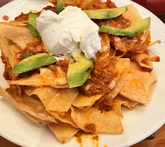 These nachos aren't trying to impress food critics – they're trying to make you happy, and that dollop of sour cream is their exclamation point.