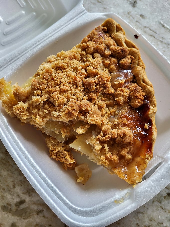 Apple crumb pie with that perfect balance of sweet fruit and buttery topping—the kind grandmothers fight over at county fairs.