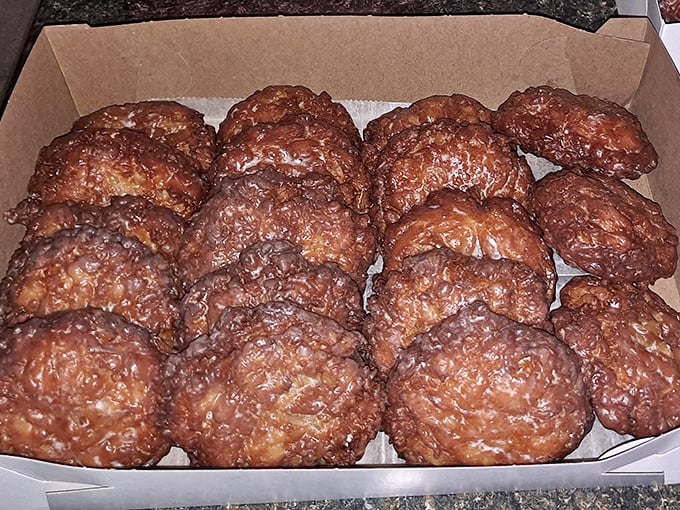 Apple fritters that could start a family feud. The powdered sugar isn't decoration—it's the final blessing in this crispy-sweet sermon.