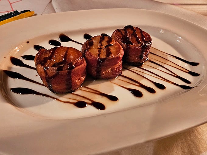 Bacon-wrapped scallops drizzled with balsamic reduction—proof that sometimes the simplest combinations are culinary magic in disguise.